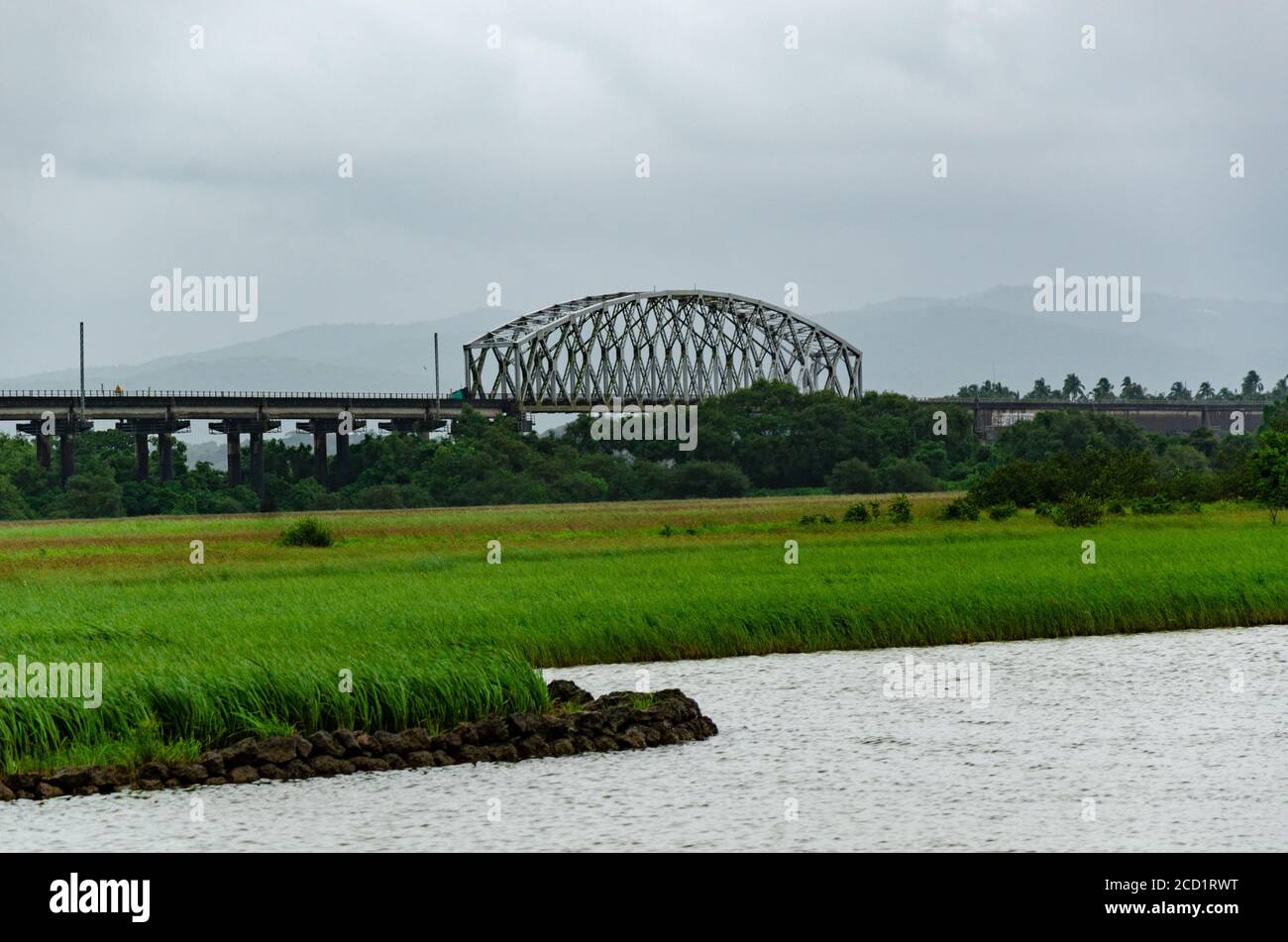 View of the Konkan Railway bridge and lush green fields at Divar Island ...