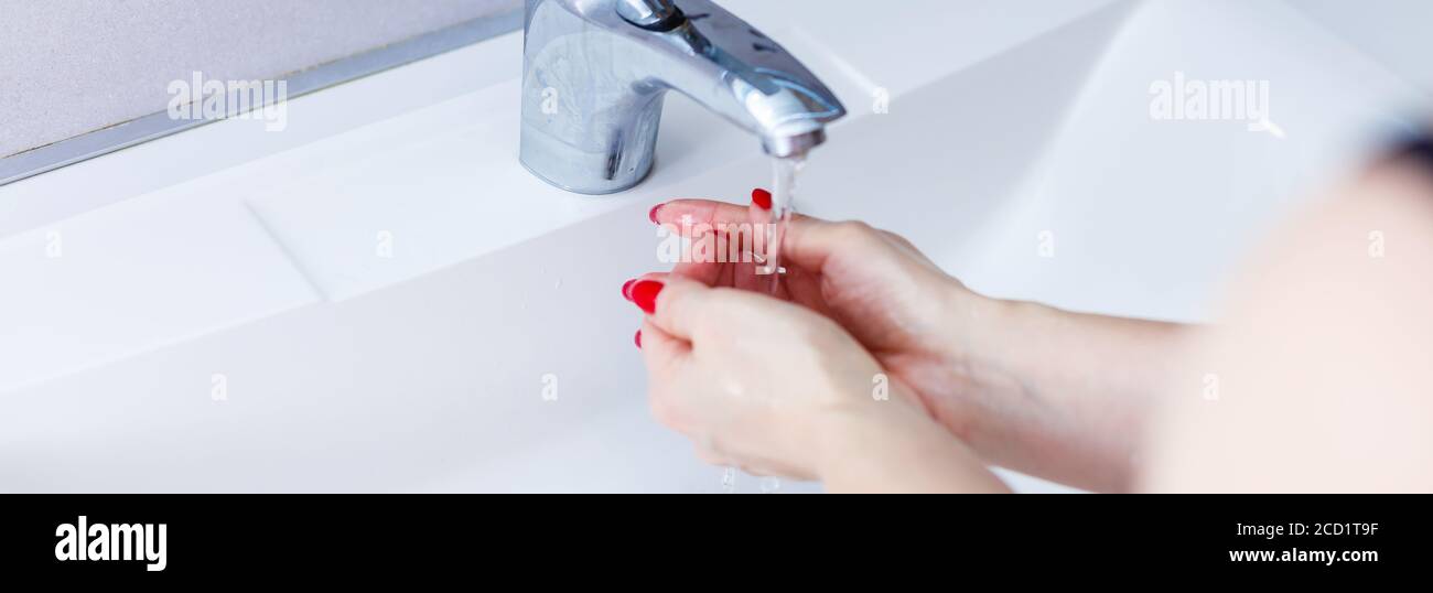 Washing woman hands with streaming water under tap in bathroom,washing ...