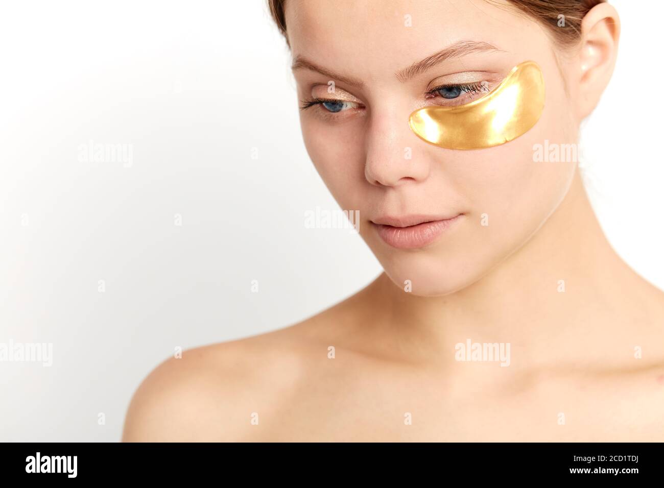 beutiful girl with natural makeup and gold cosmetics collagen patches ...