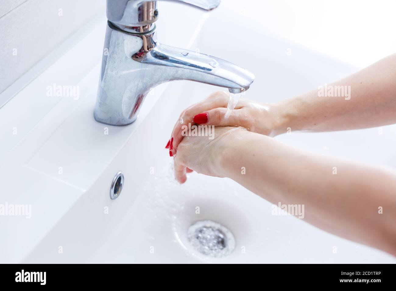 Washing woman hands with streaming water under tap in bathroom,washing ...