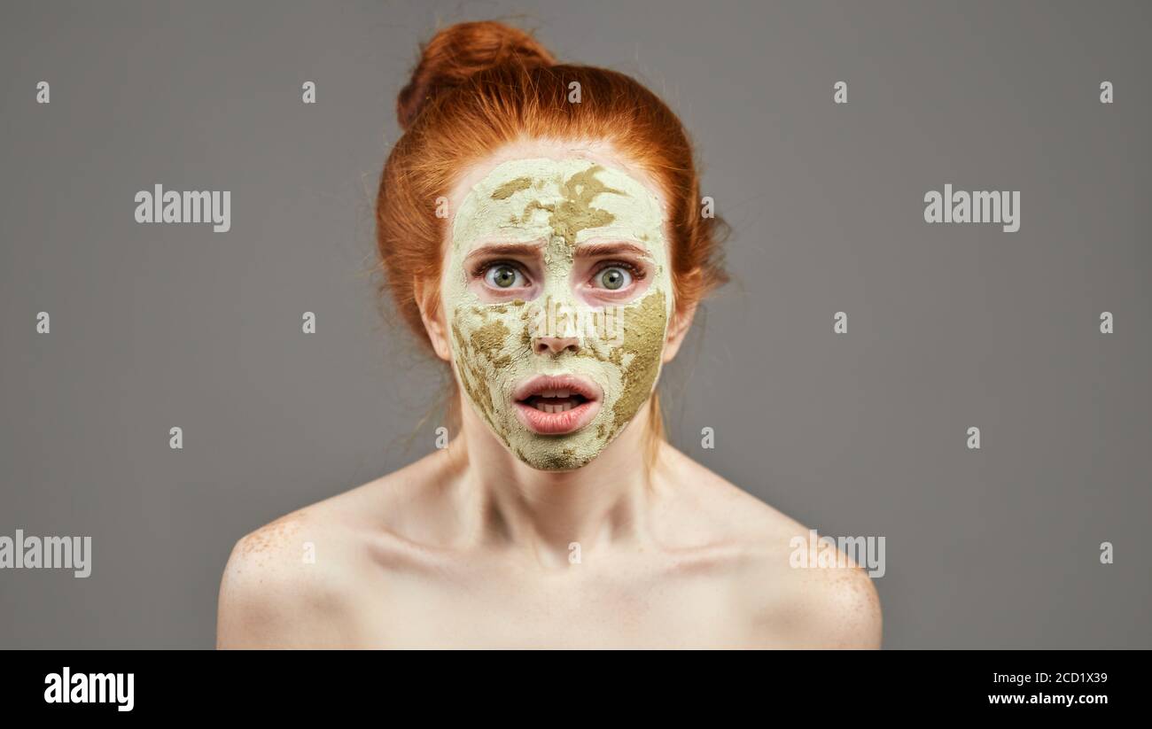 frustrated girl doesn't like the mask. ginger woman with shocked ...