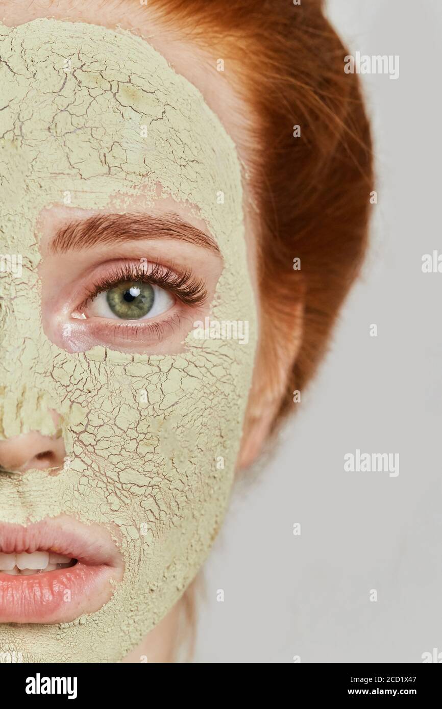awesome beautiful girl with green face. close up cropped portrait ...