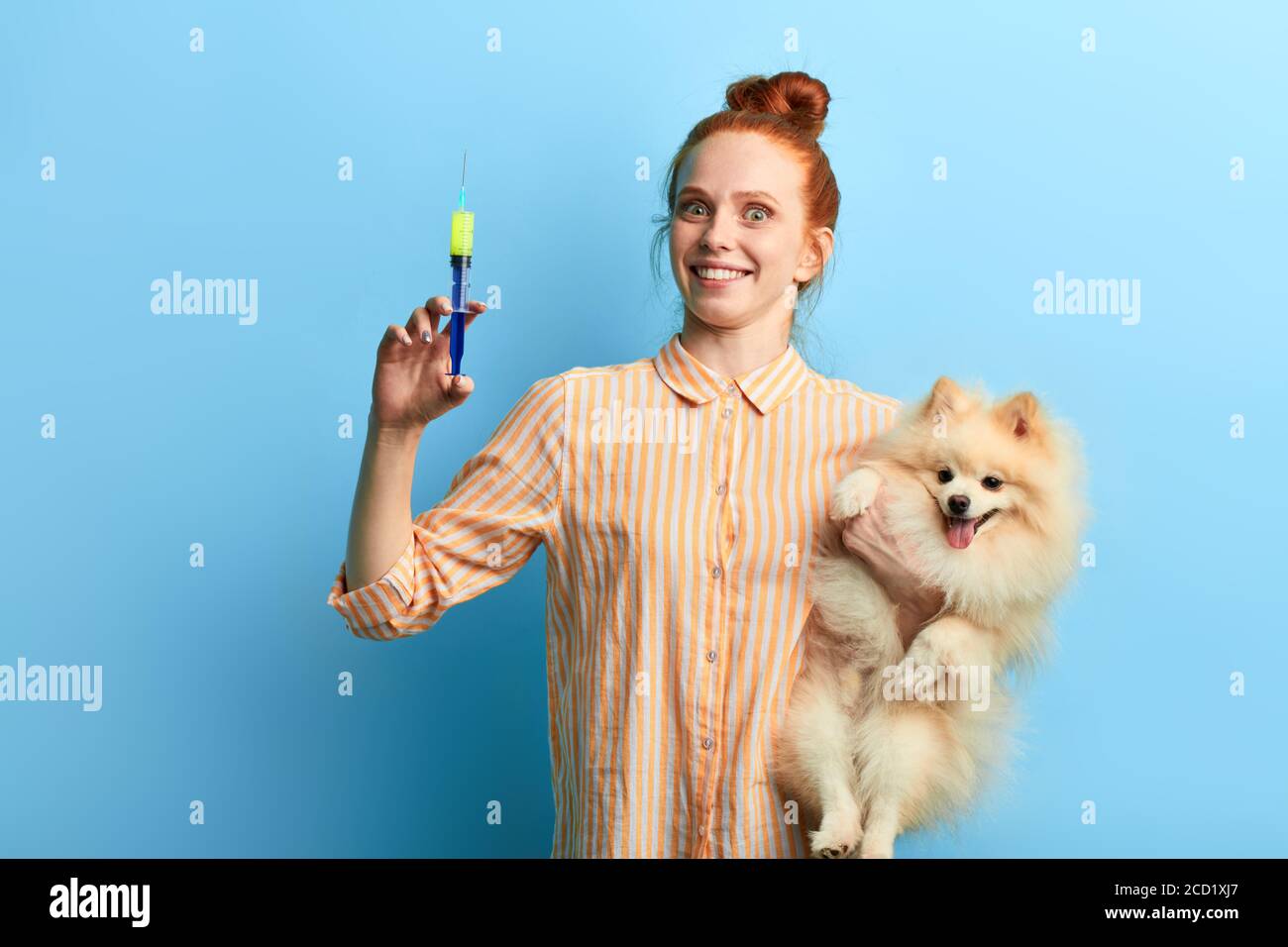 funny smiling excited vet going to give injection to the pet, isolated ...