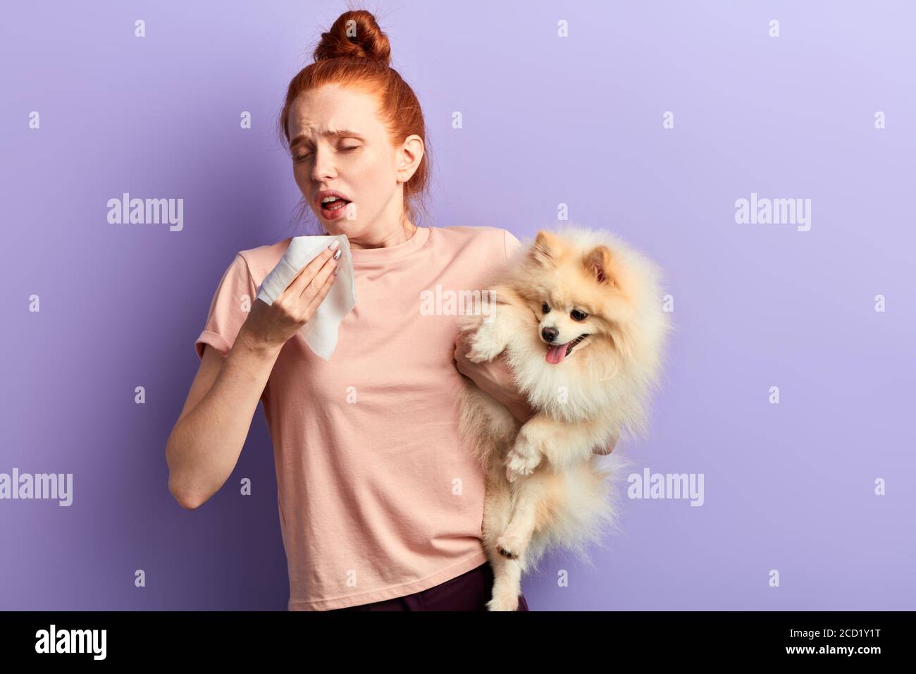 young attractive ginger girl suffering from pet allergy. close up ...