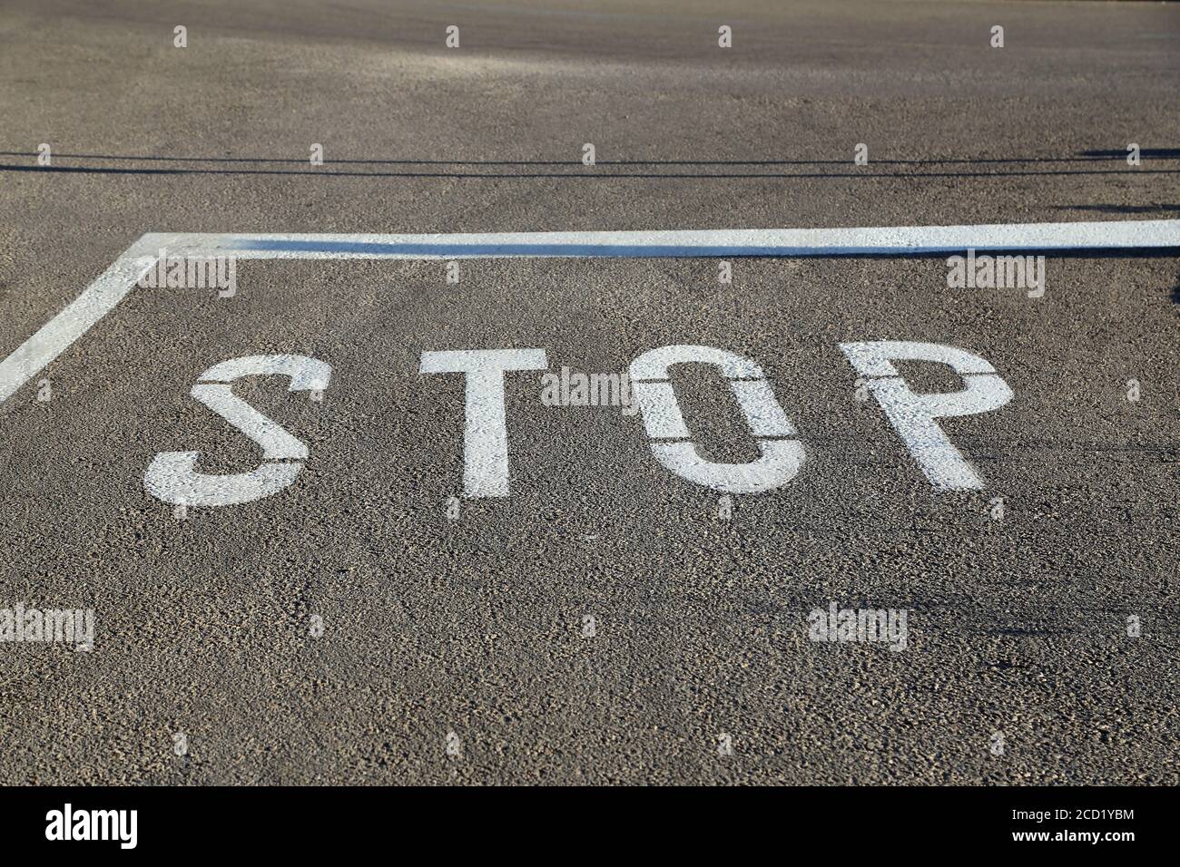 Closeup shot of Stop sign road marking on the asphalt at the ...