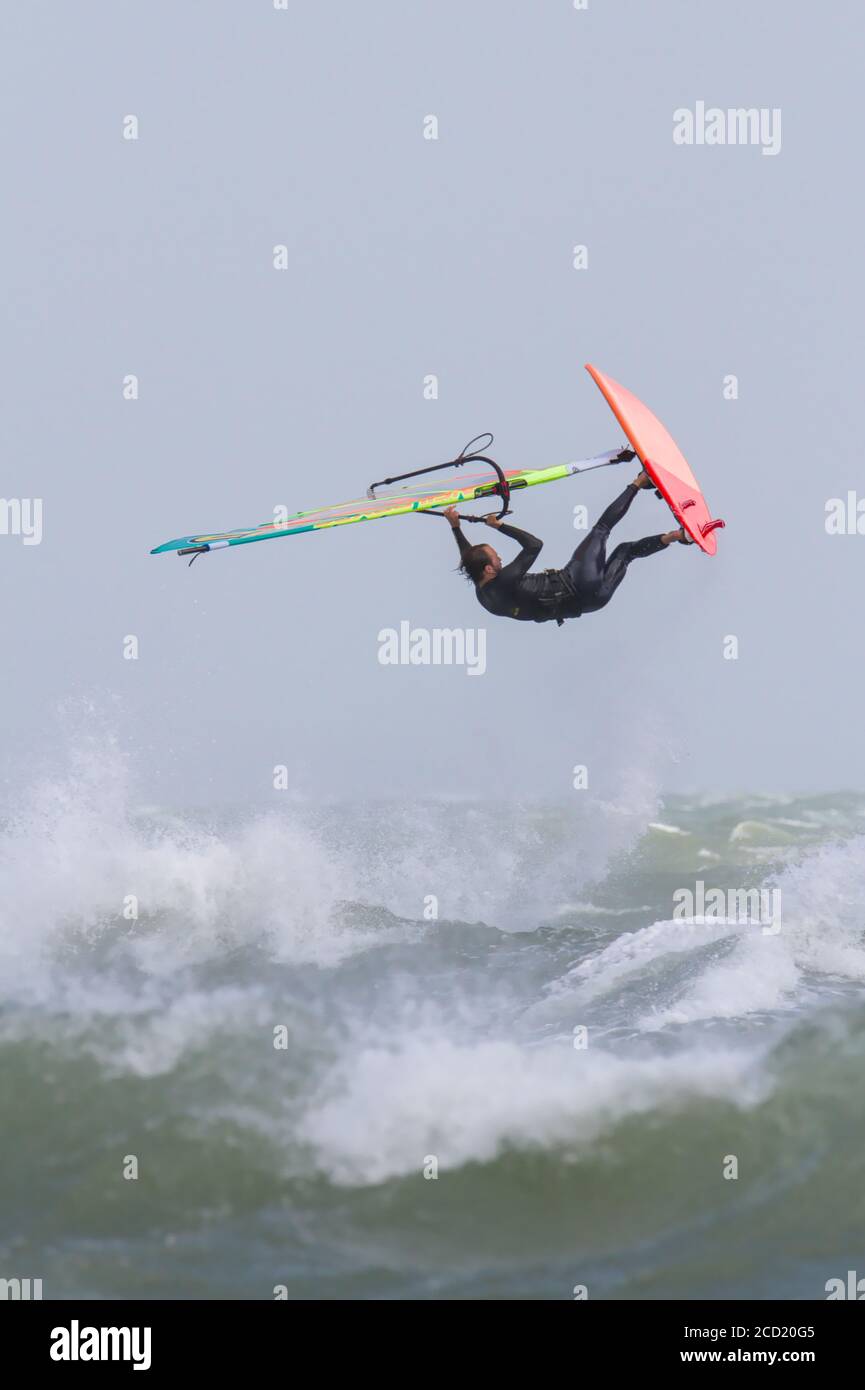 Airborne Windsurfer Doing A Front Loop Jumping A Large Wave At Avon ...