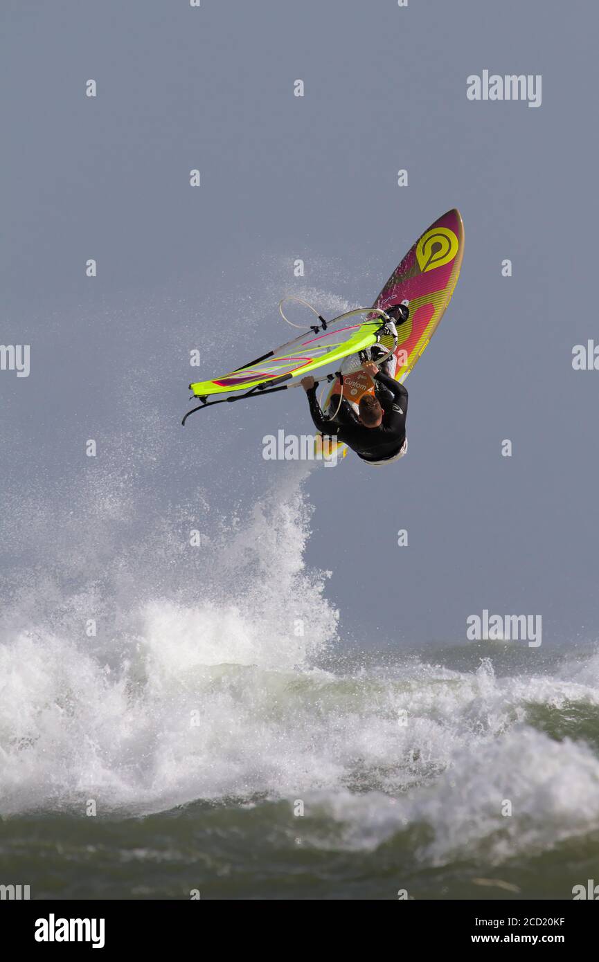 Airborne Windsurfer Doing A Front Loop Jumping Large Waves During Storm ...