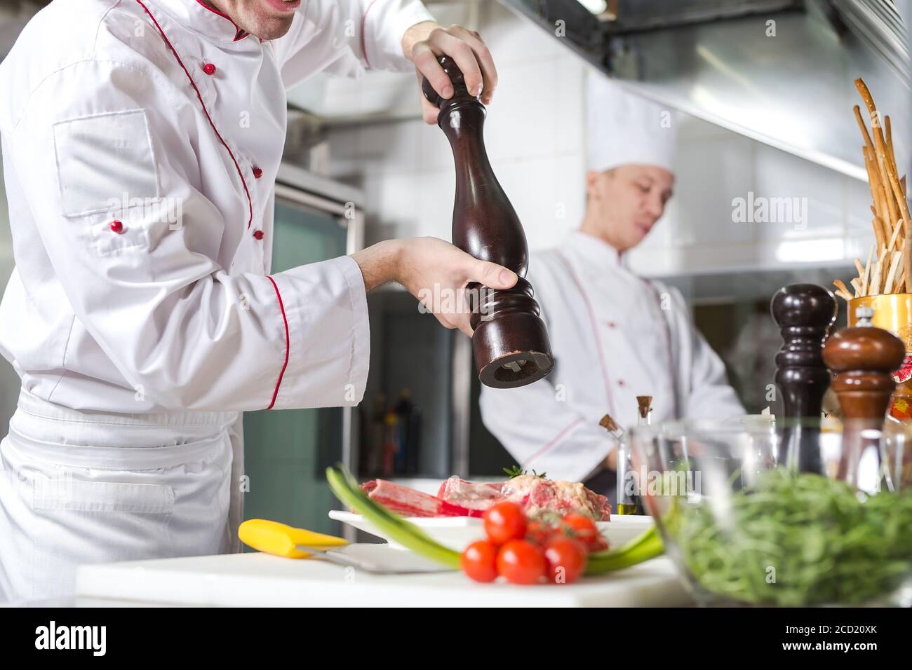 The chef prepares a dish in the kitchen of restoran Stock Photo - Alamy