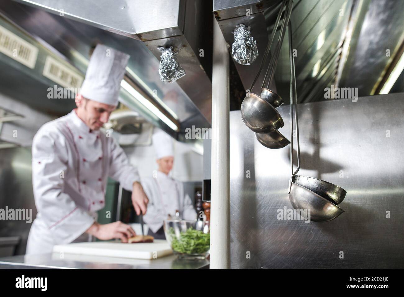 Chef cutting meat on chopping board, professional cook holding knife ...