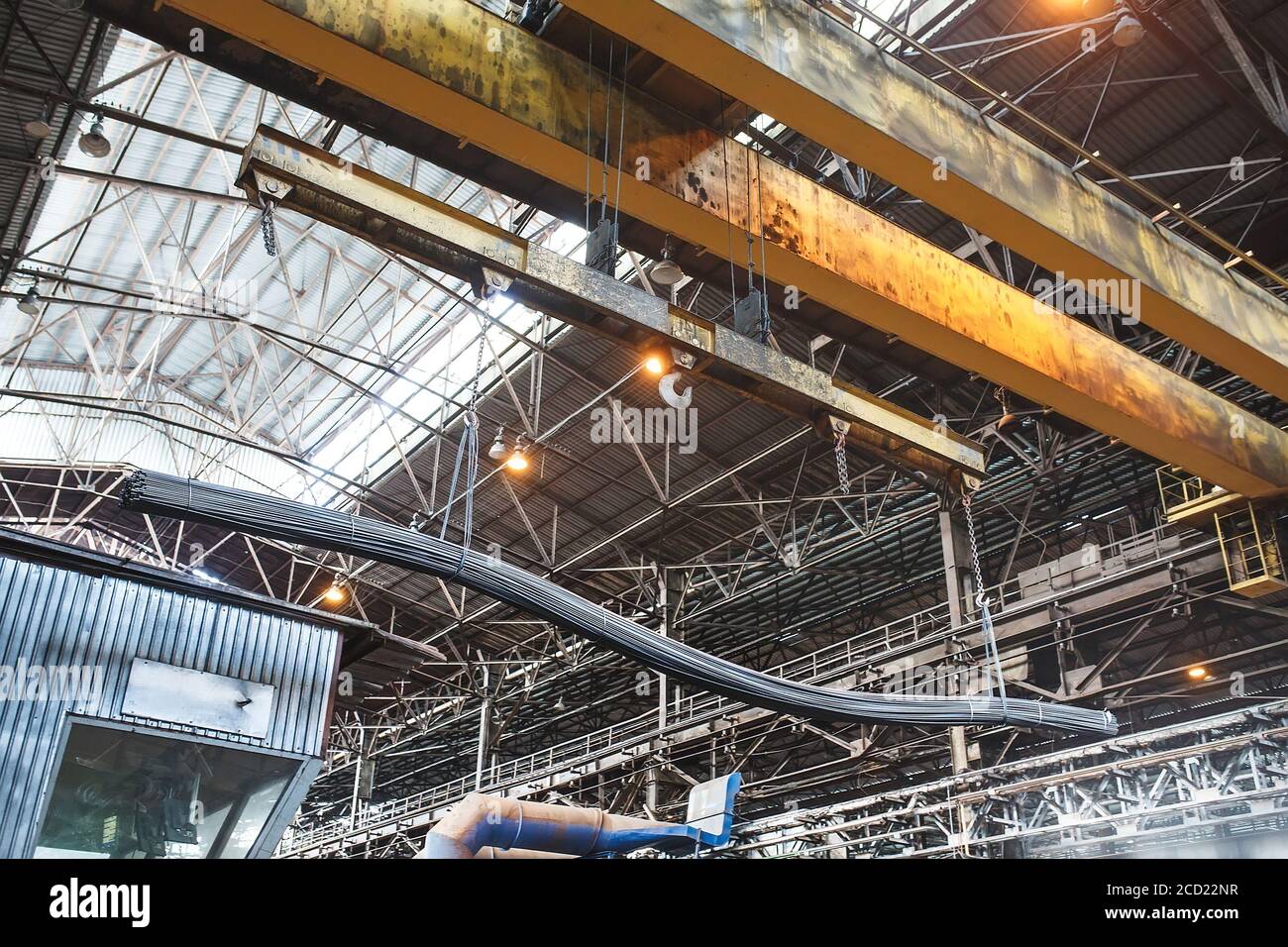 Crane loader carries rebar and wire rod in the factory Stock Photo - Alamy