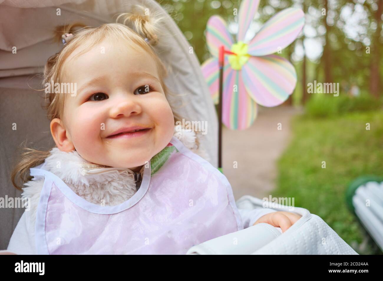 Portrait of happy caucasian child sitting in pram after eating Stock ...