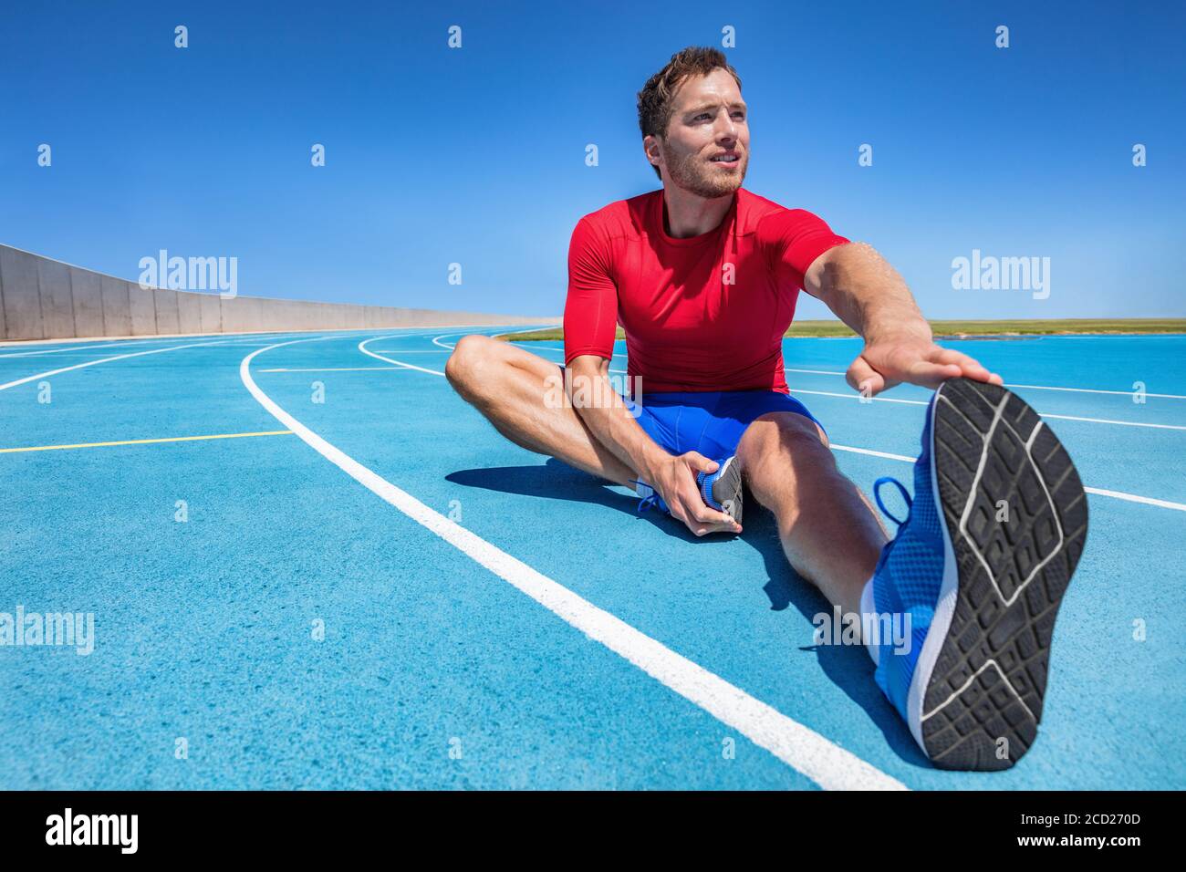 Man runner stretching legs preparing for run training on outdoor ...