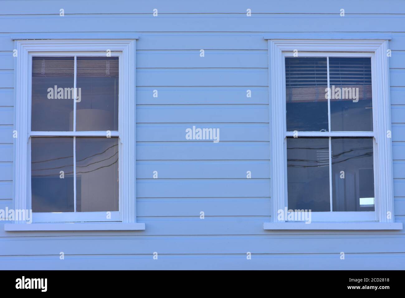 Vintage windows with four glass panes on wooden pale blue wall with ...