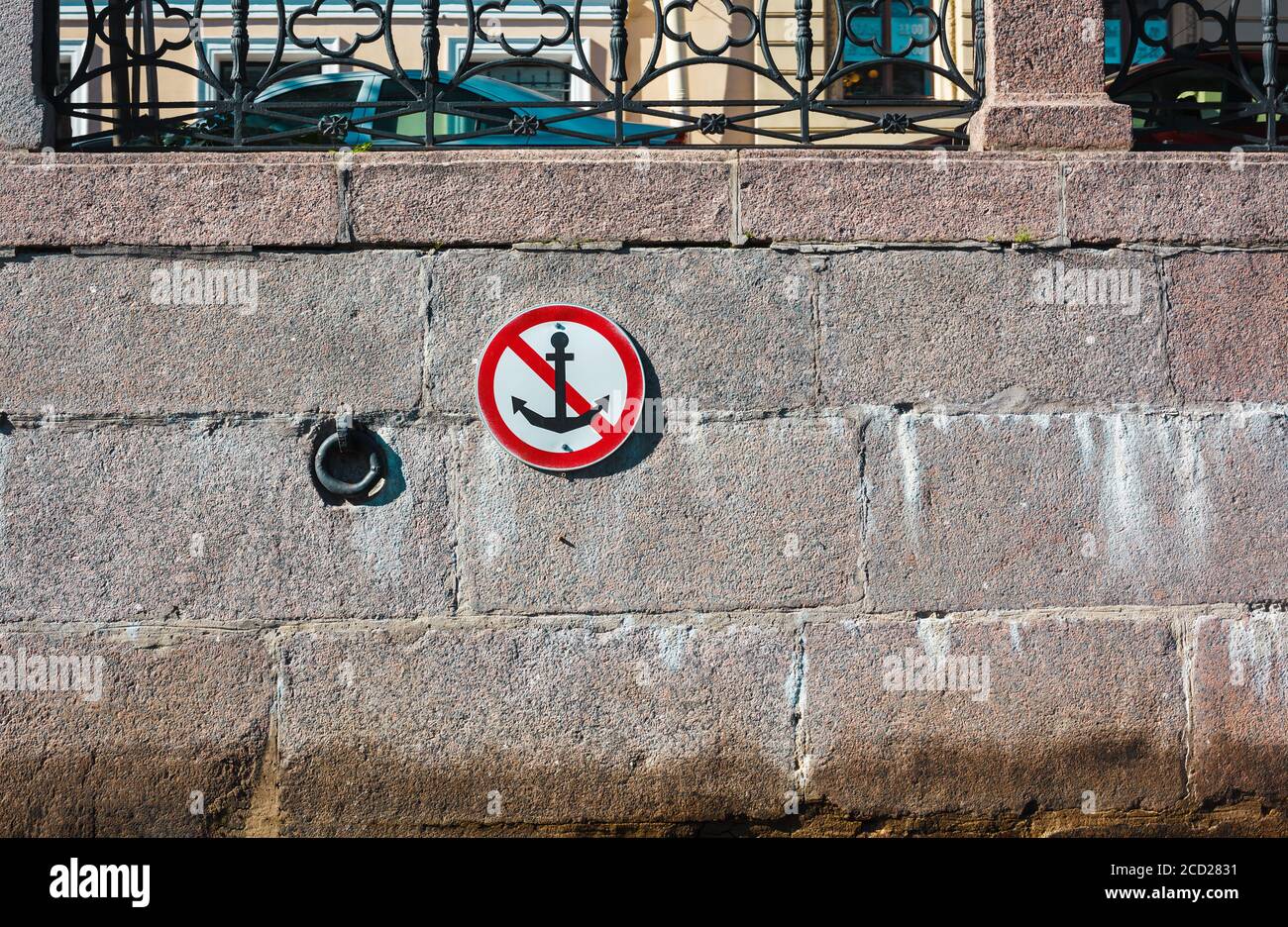 Traffic sign with crossed out anchor on granite embankment of city ...