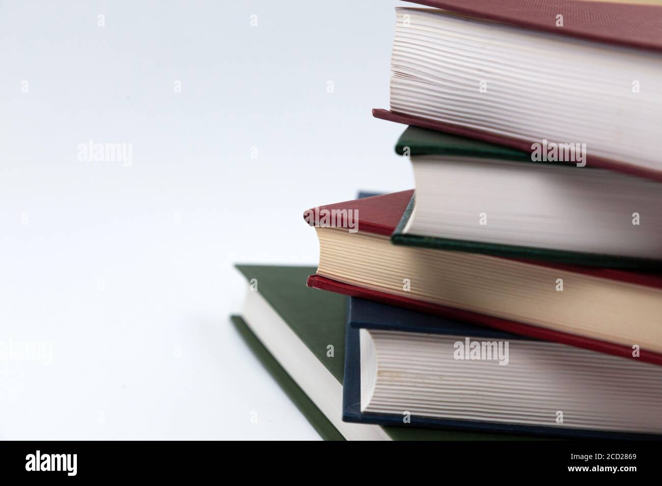 Book stack on a white background. Education concept side view close up ...