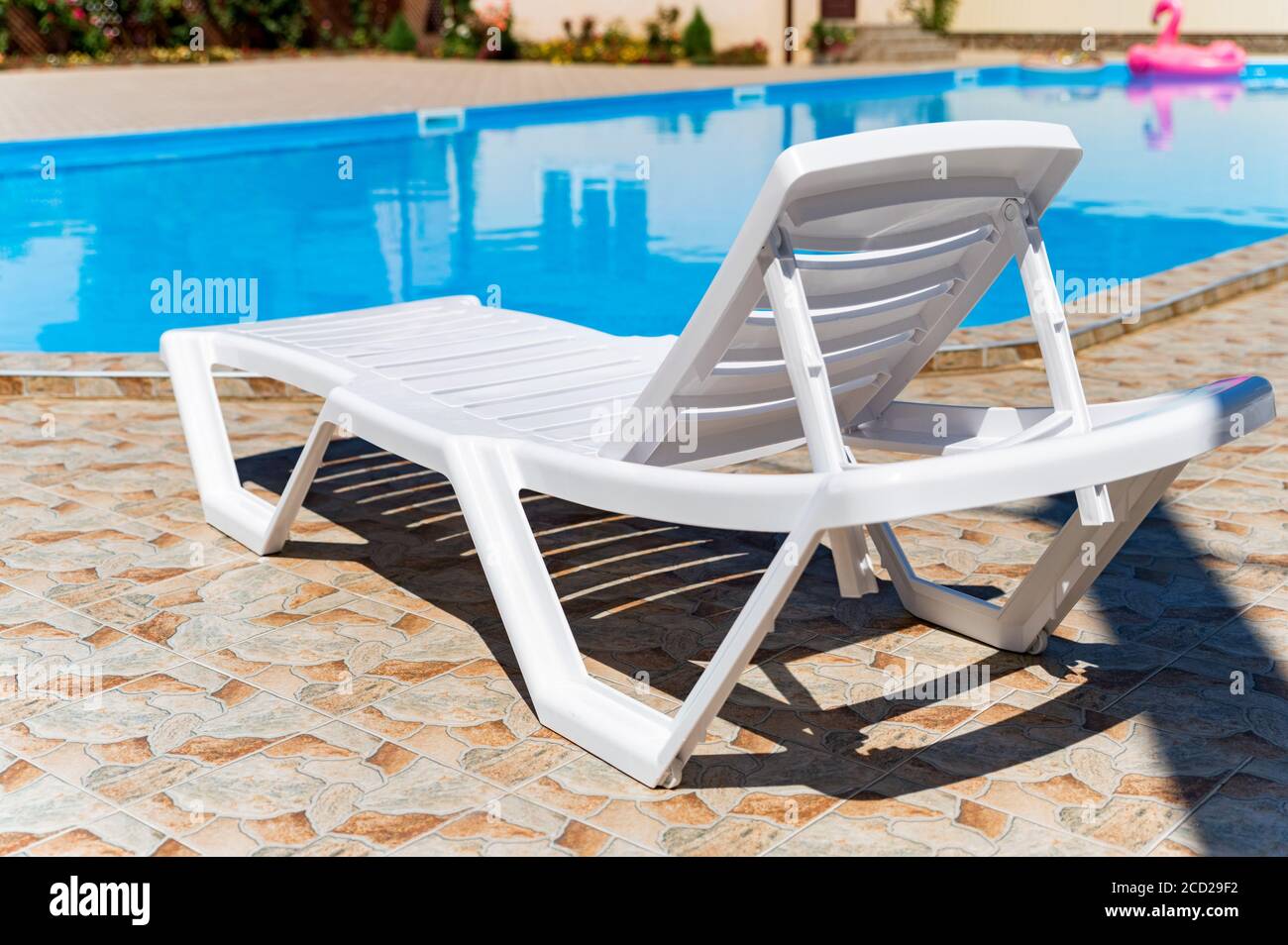 Empty plastic white deck chairs near the swimming pool Stock Photo - Alamy