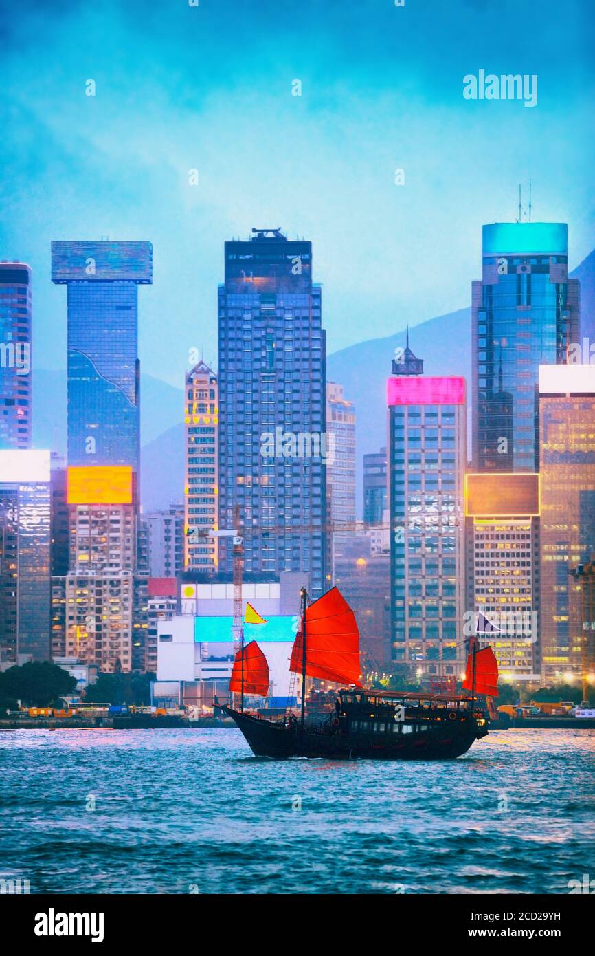 Hong Kong skyline view at dusk of Victoria Harbour from the Tsim Sha Tsui side with neon signs ...