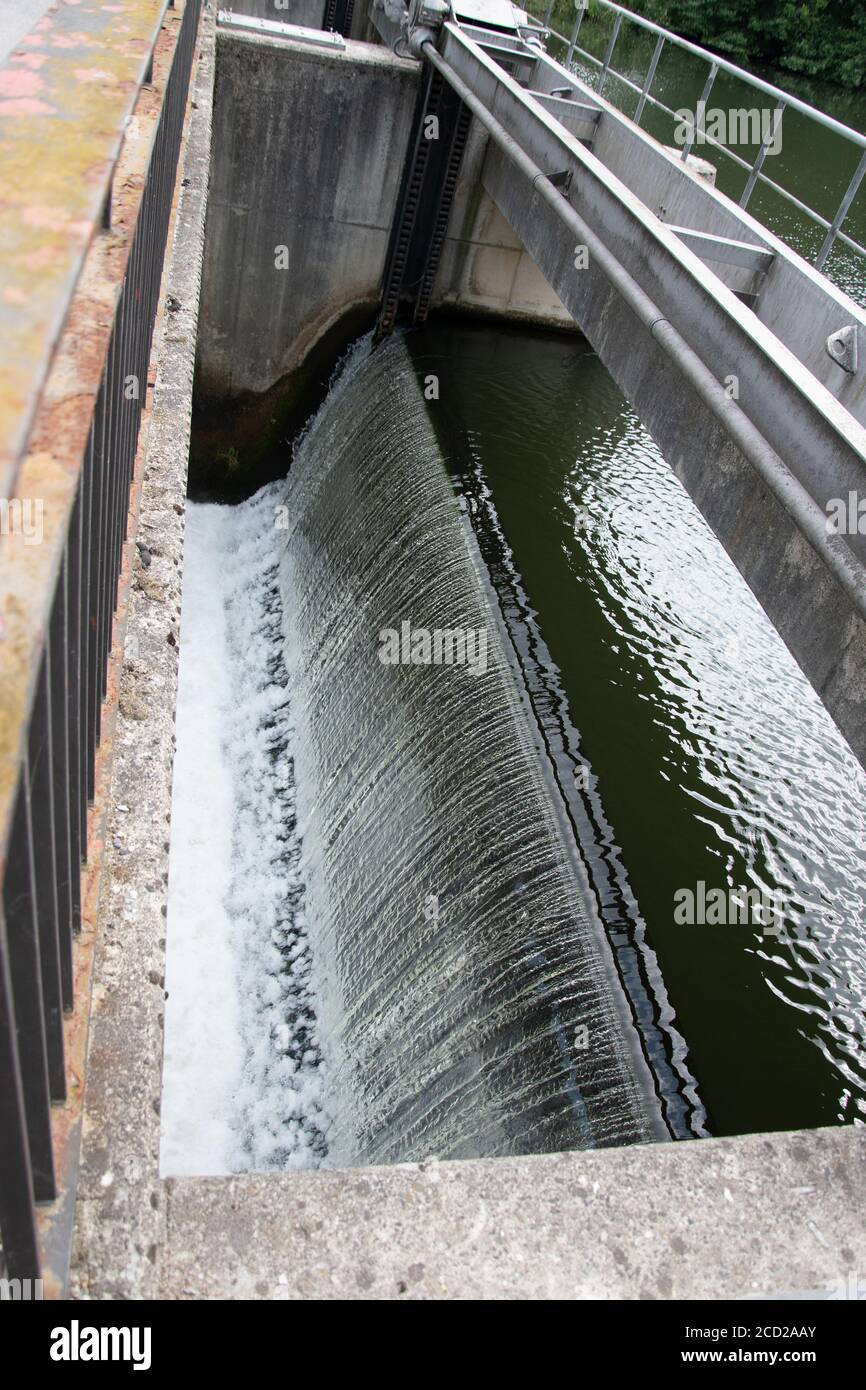 Vertical dutch angle shot of water flowing in a dam Stock Photo - Alamy