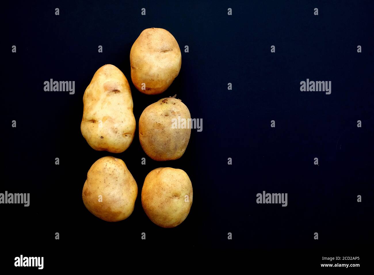Five potato heads on dark background Stock Photo - Alamy