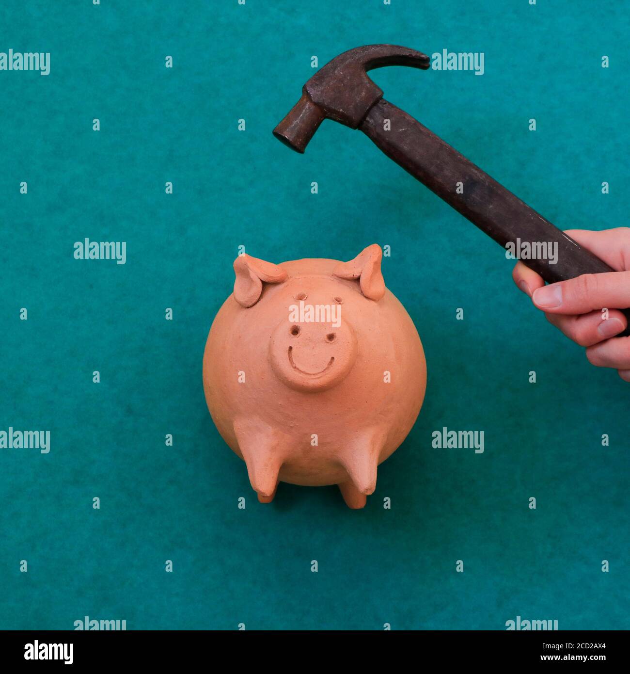 Breaking pig coin with hammer Stock Photo - Alamy