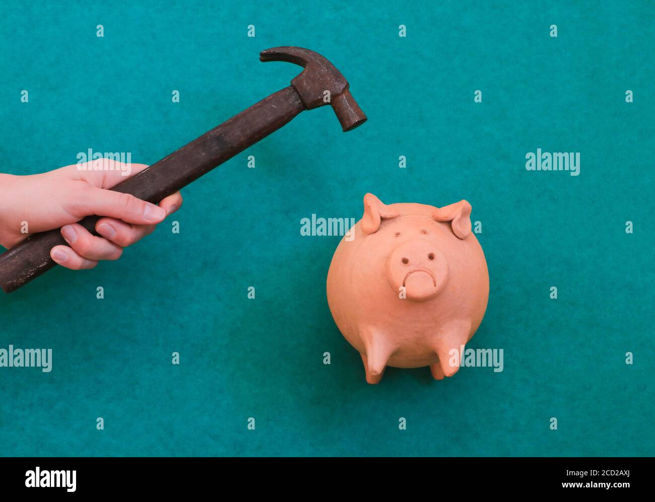 Breaking pig coin with hammer Stock Photo - Alamy