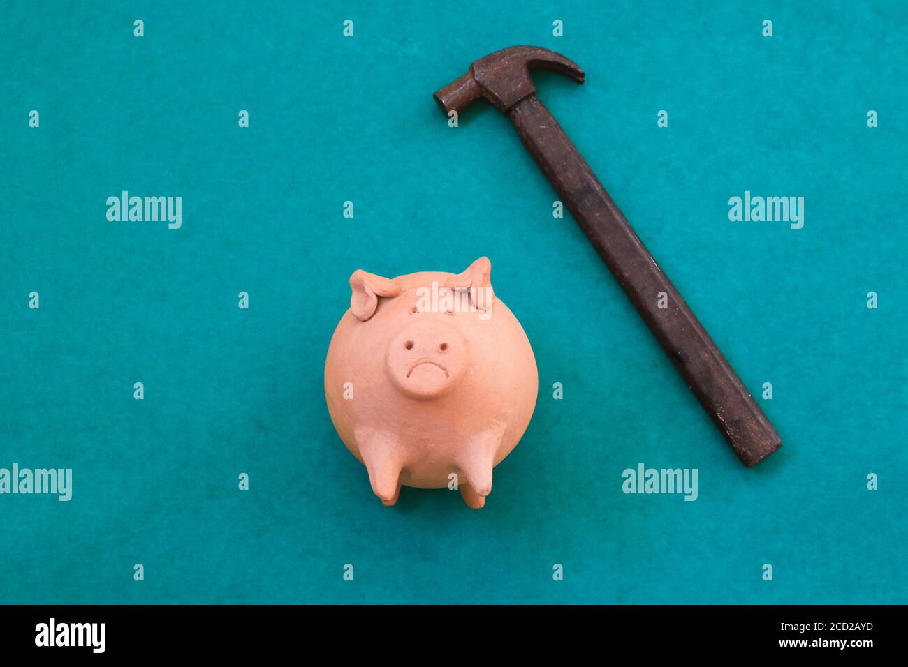 Breaking pig coin with hammer Stock Photo - Alamy