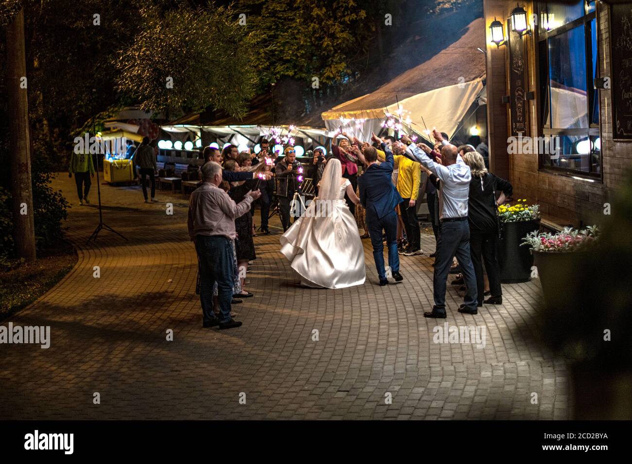Guests Throwing Confetti Over Bride And Groom At Wedding Stock Photo ...
