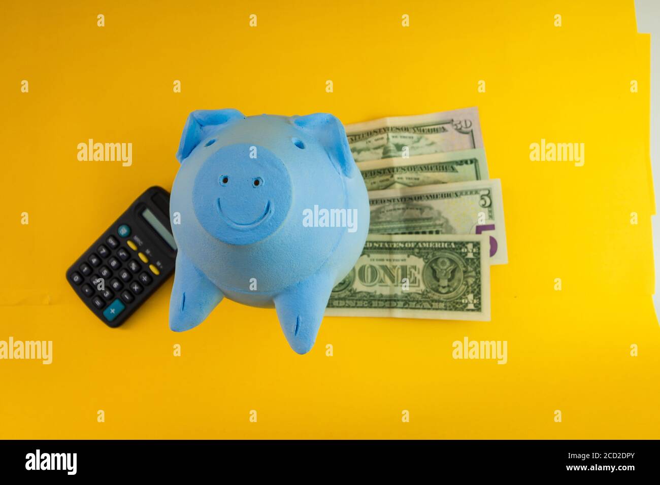 Piggy coins with calculator and dollars isolated Stock Photo - Alamy
