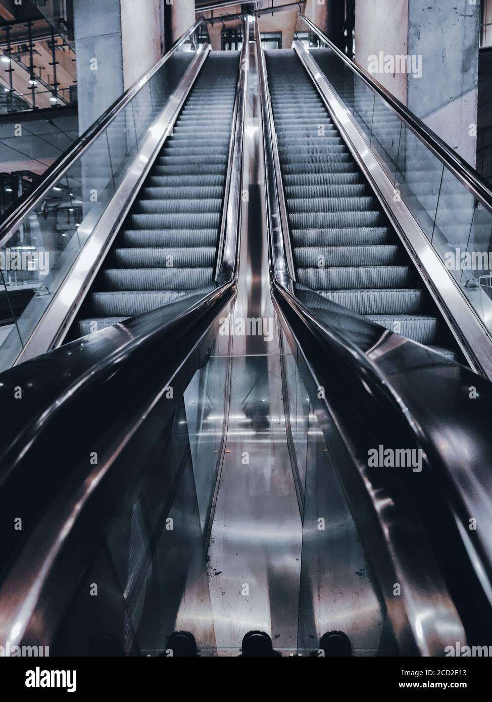 Vertical low angle shot of modern escalators Stock Photo - Alamy