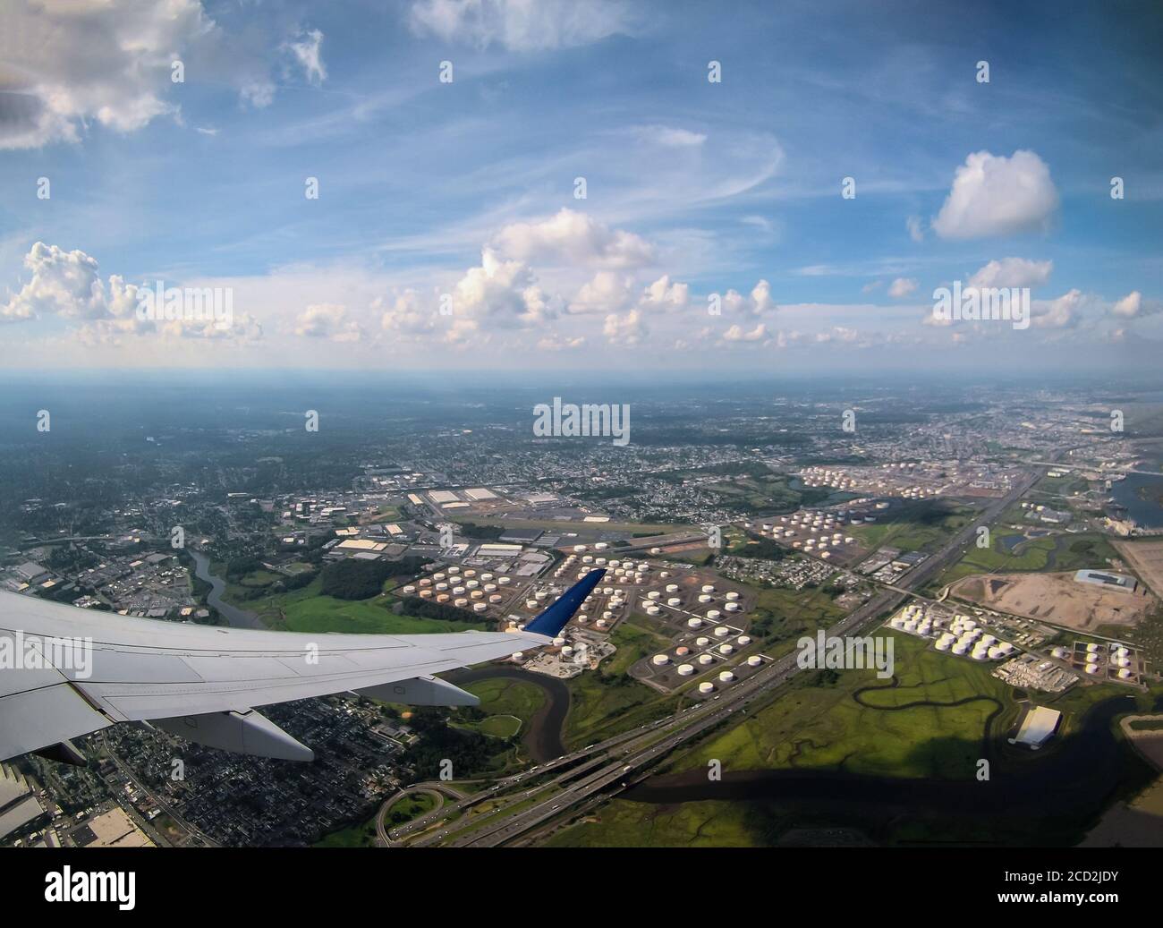 Airplane travel flying above the scenery landscape wing look through in ...