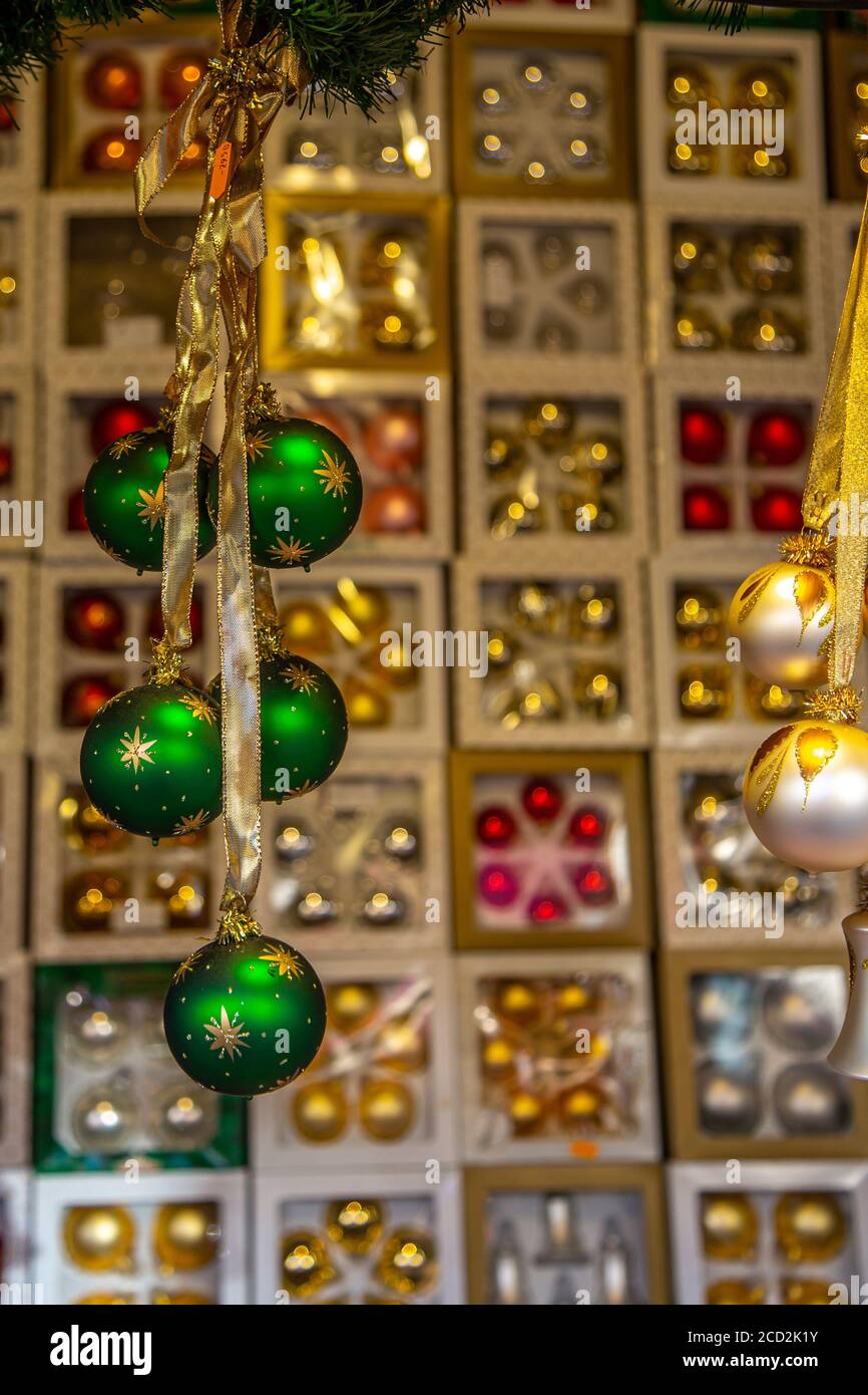 Christmas baubles hanging in front of a variety of blurry boxes with ...