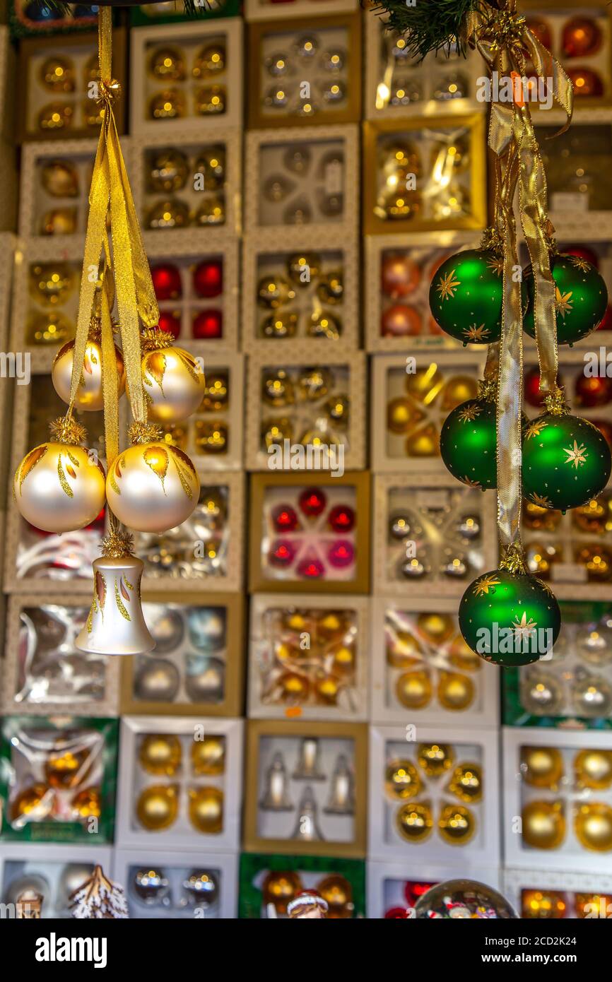 Christmas baubles hanging in front of a variety of blurry boxes with ...