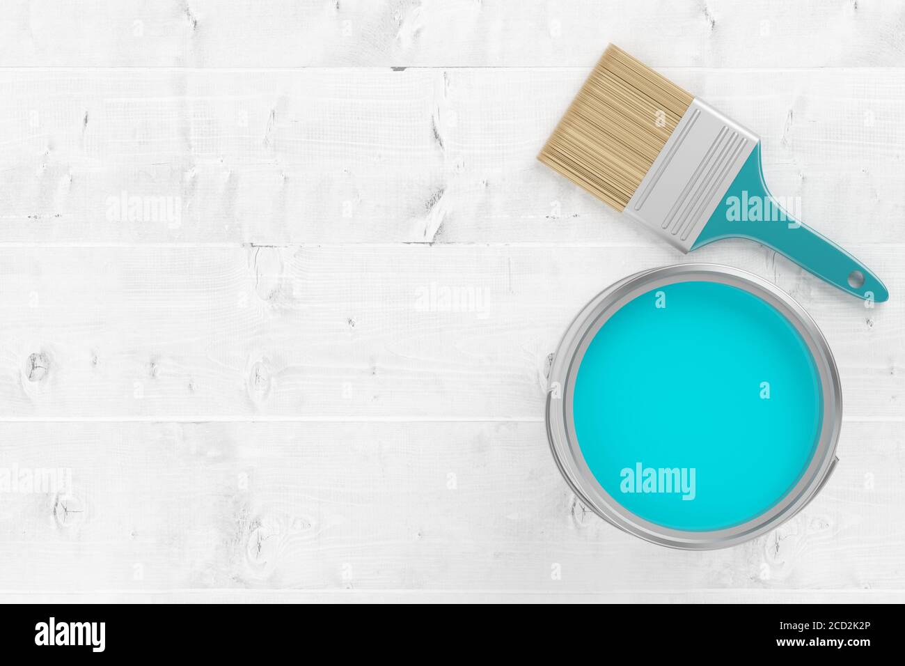 Paintbrush with silver paint bucket with cyan paint on white wooden ...