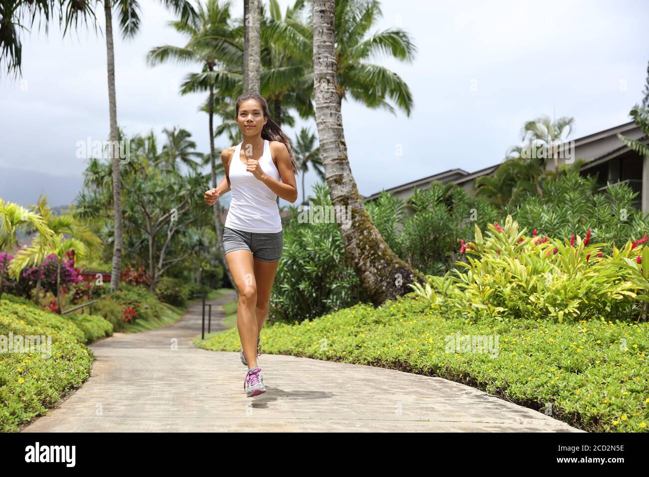 Happy healthy active lifestyle girl runner running. Asian woman jogging ...