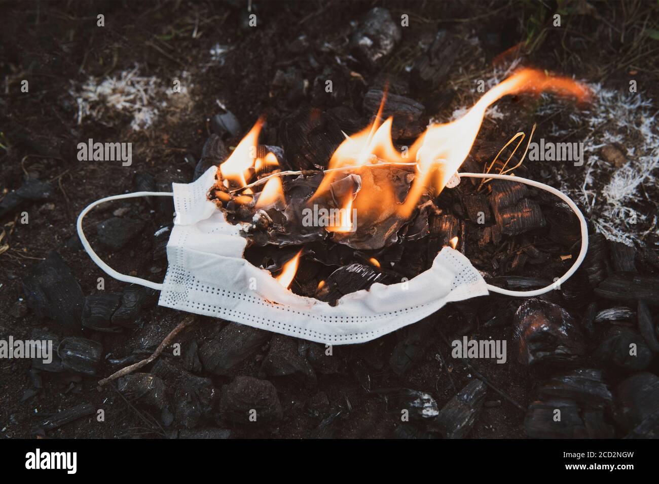 Burning a medical mask, surgical mask with cleansing decontaminate fire ...