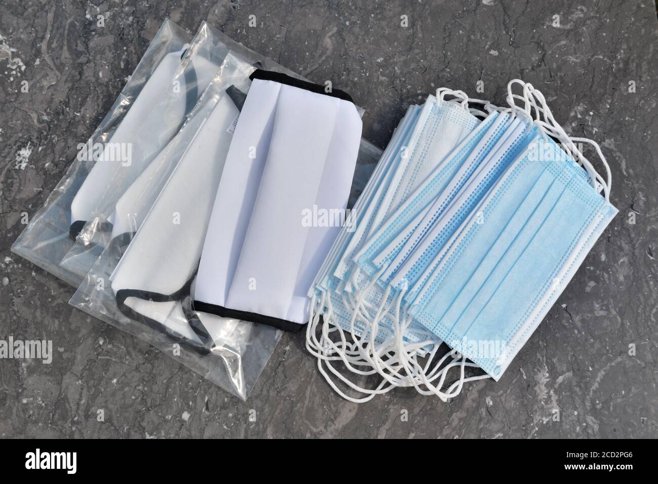 heap of surgical and textile face masks on grey marble background Stock ...
