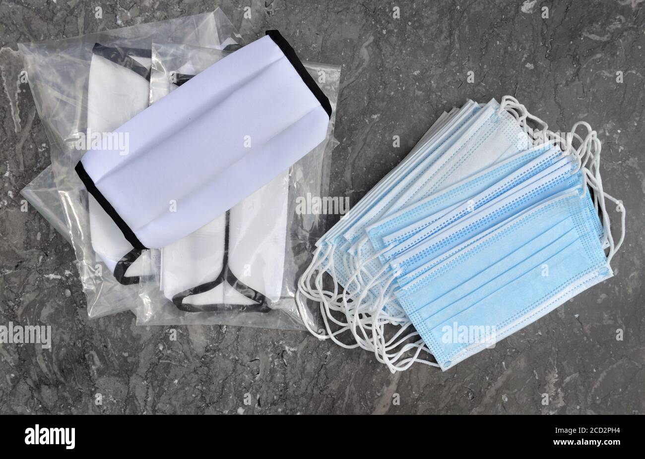 heap of surgical and textile face masks on grey marble background Stock ...