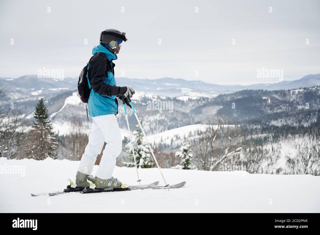 Man skier looking at beautiful snowy mountains at ski resort. Concept ...