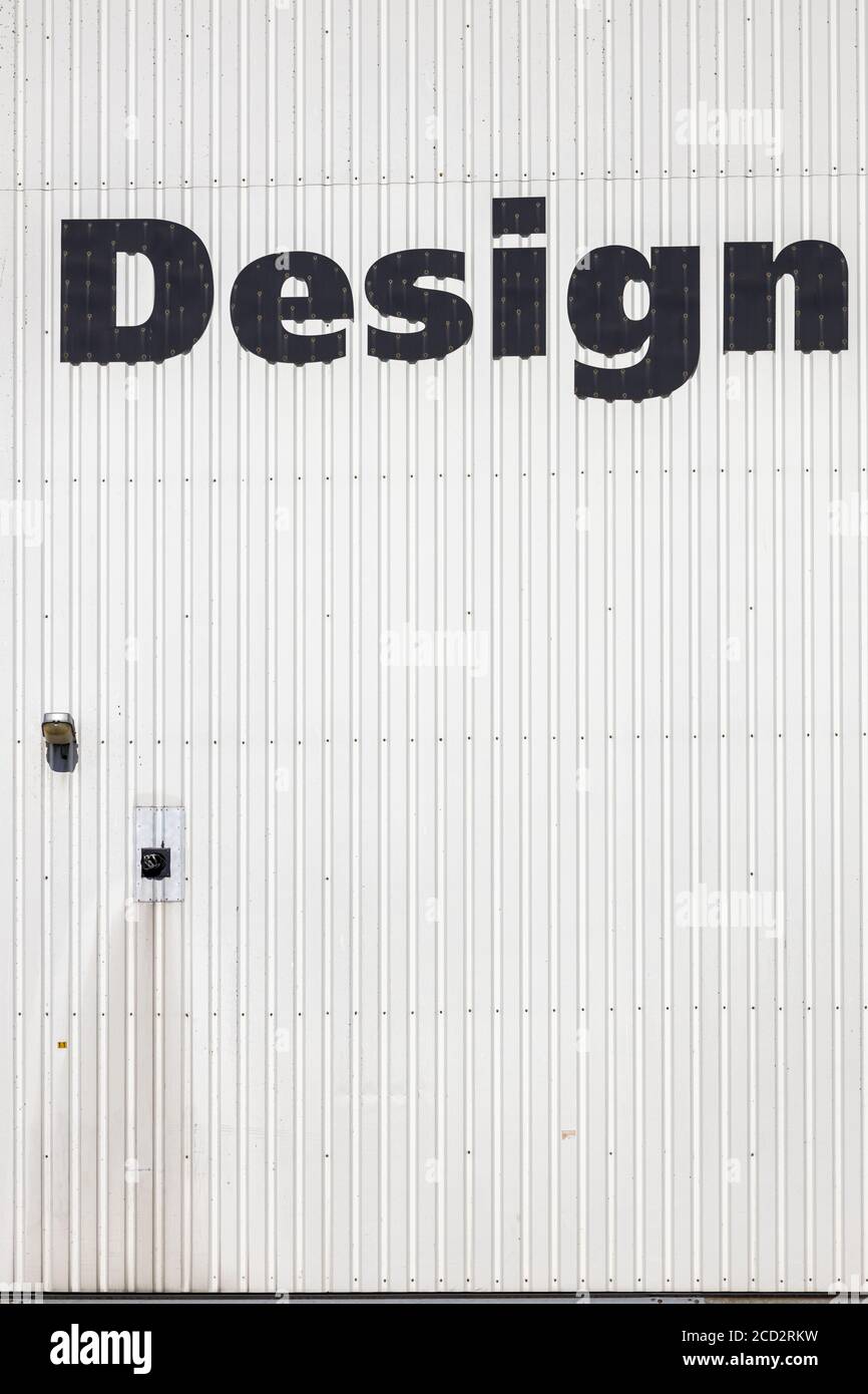 Textured white wall with Design written Stock Photo - Alamy