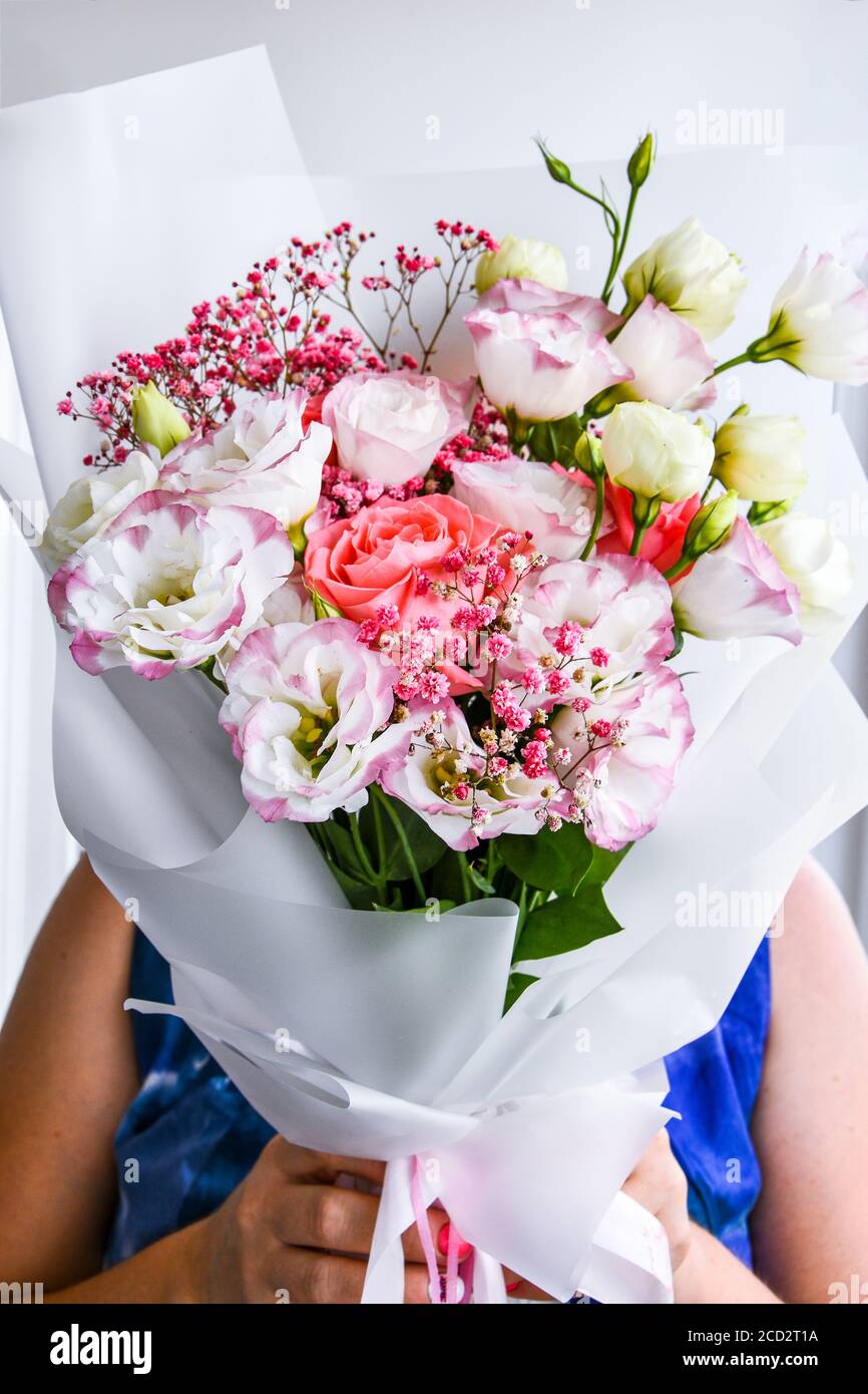 Beautiful woman hands hold bouquet of different flowers white and ...