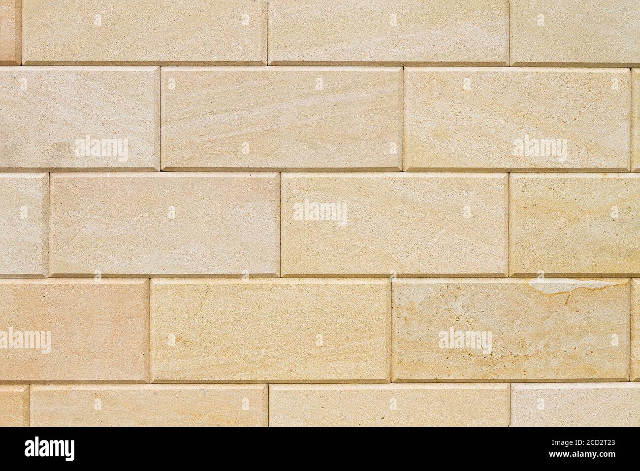Marmoreal stone wall of repetitive brick. Beige color Stock Photo - Alamy