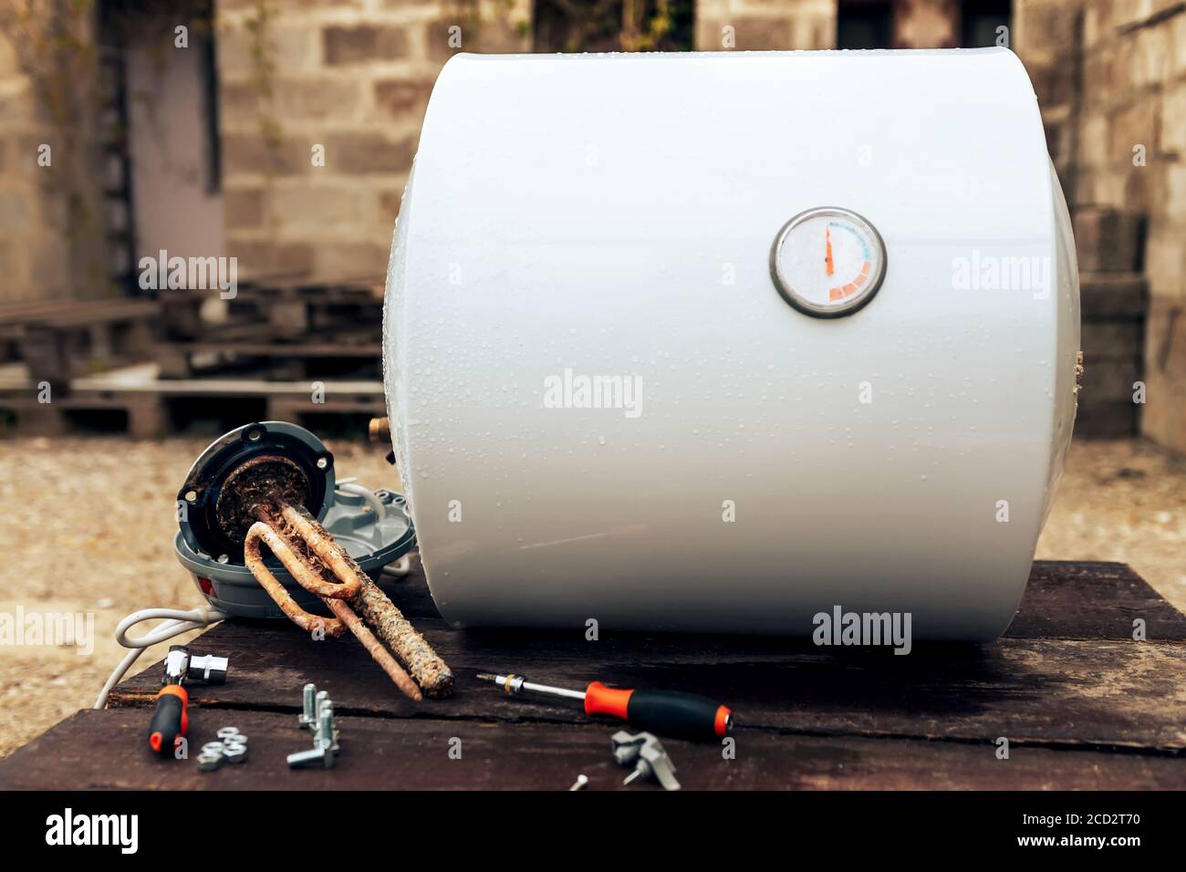 boiler disassembled, lying next to the heating element, nuts and tools ...