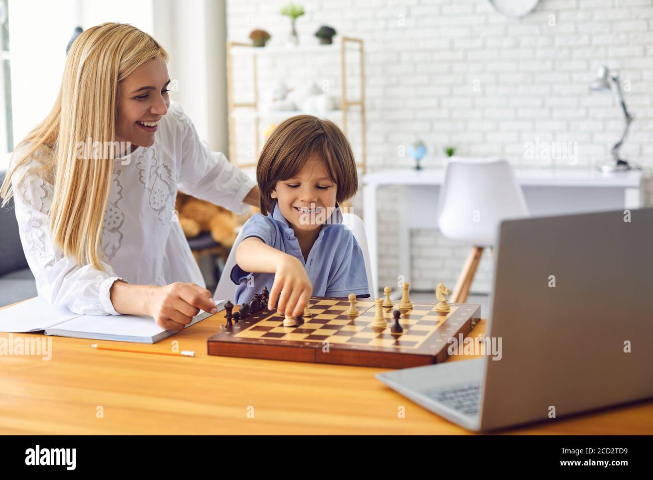 Mom and son play chess in the room. Educational games for children ...