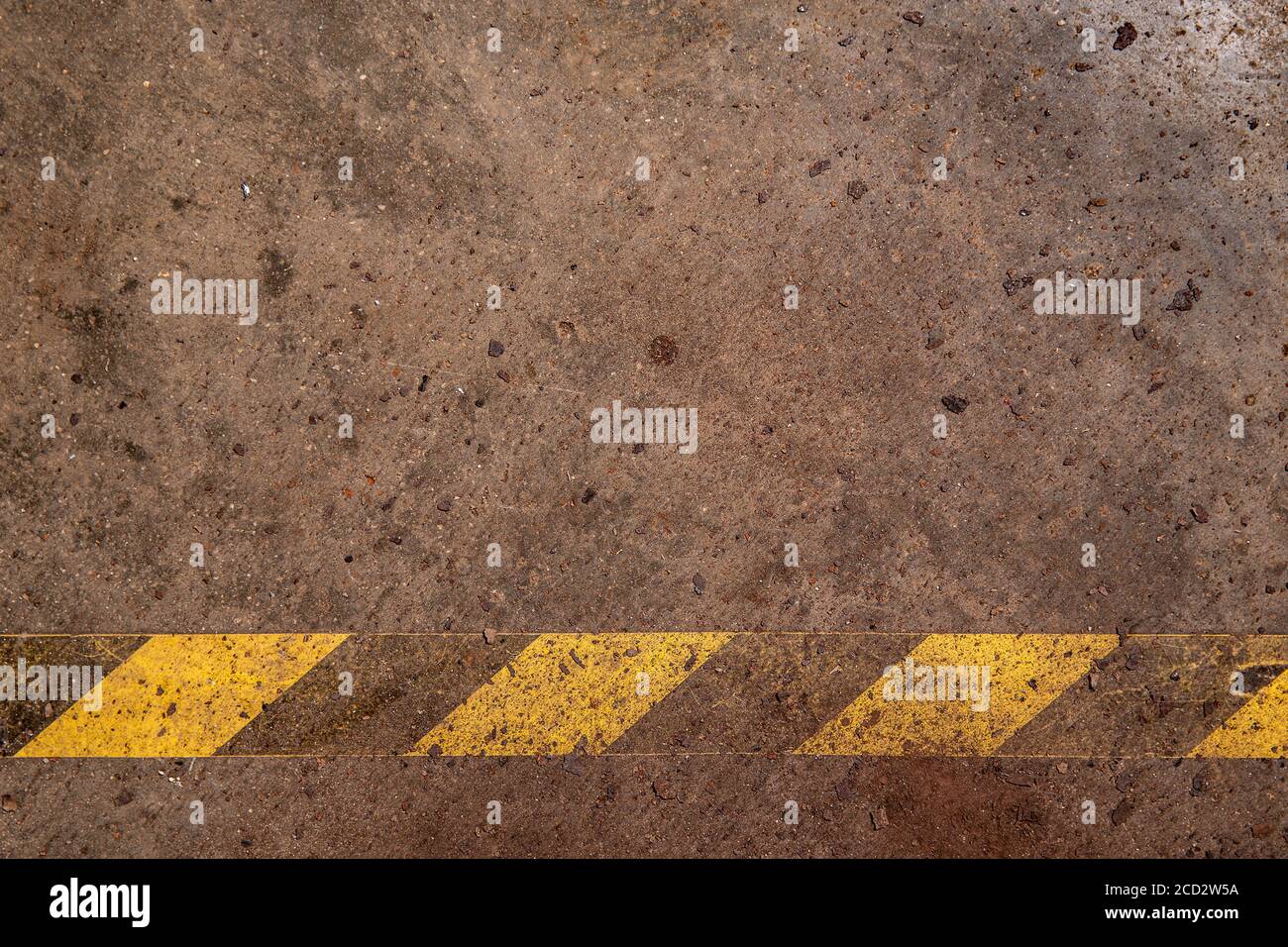 Yellow-black signal strip at the car workshop floor Stock Photo - Alamy