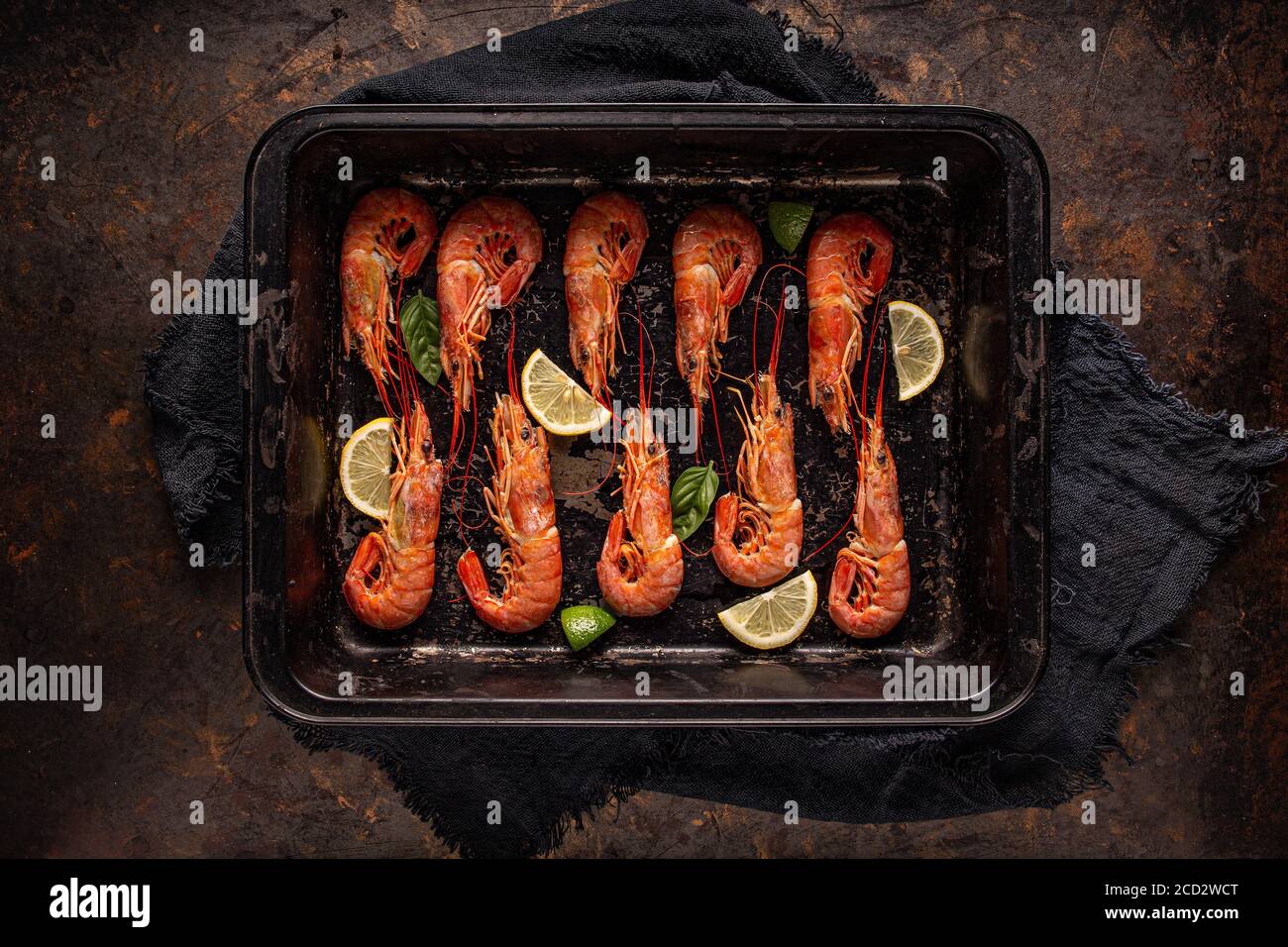 Top view of king prawns on a black backing tray ready for cook Stock ...
