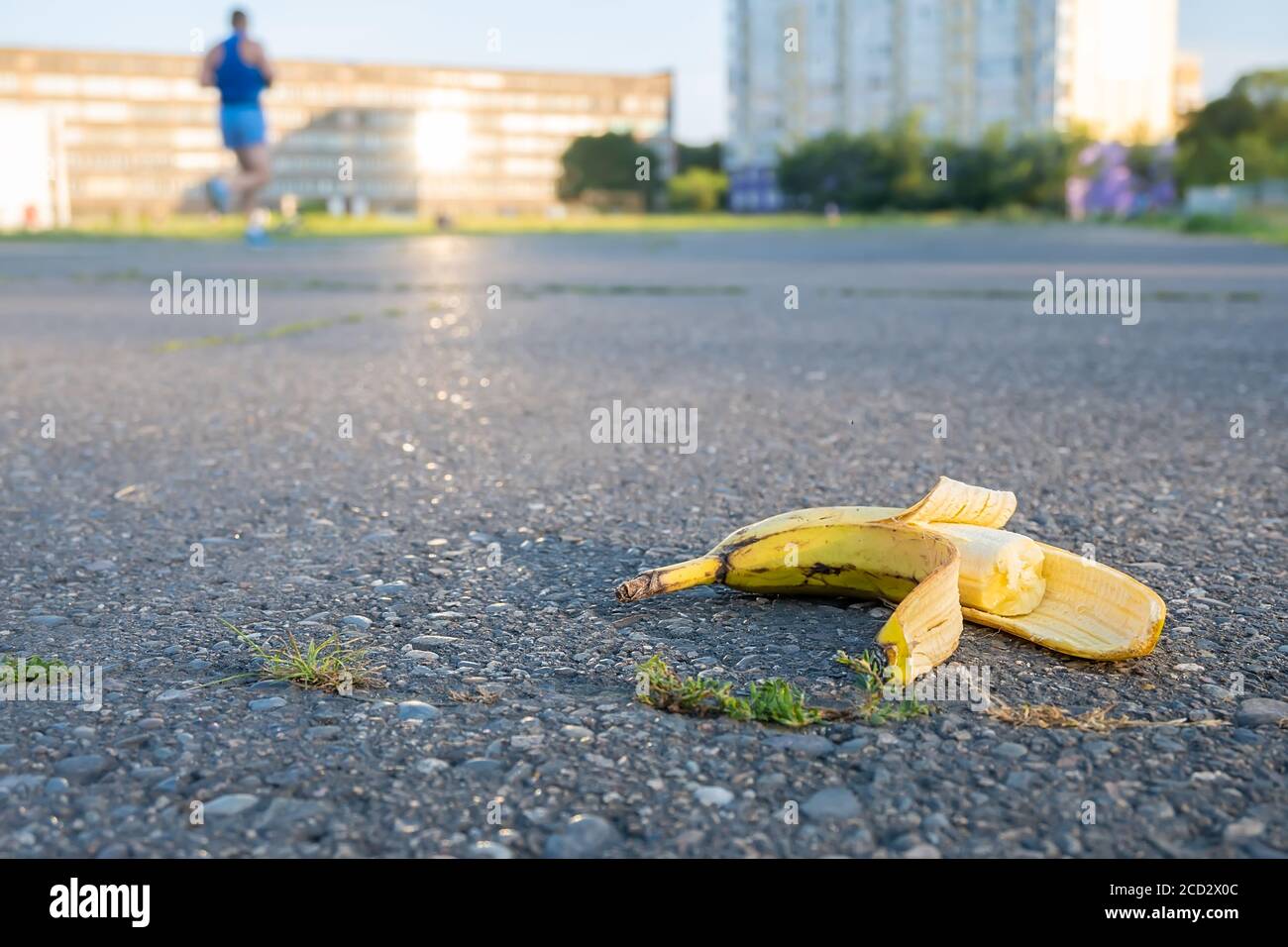 a discarded bitten banana is lying on the running track of the stadium ...
