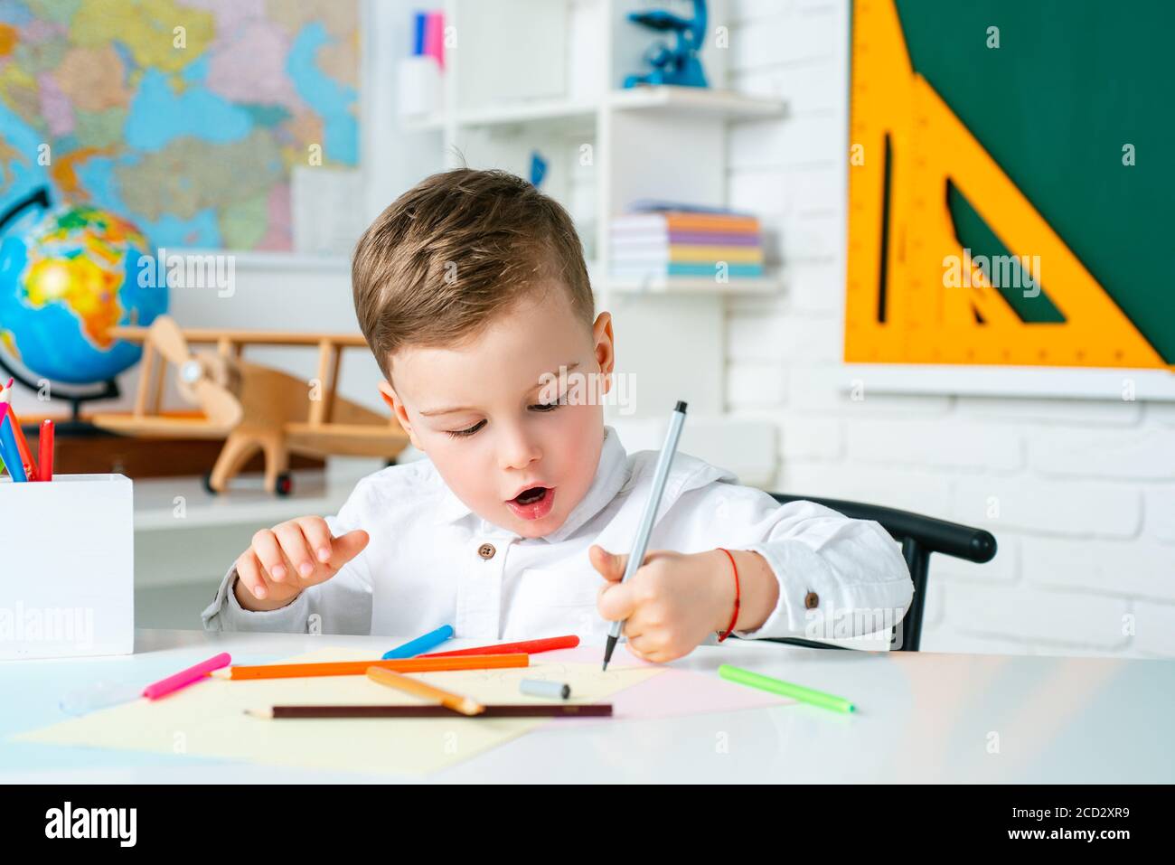 Cute kid at home or daycare. Child studying from home. Elementary ...