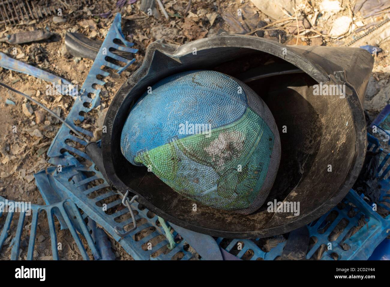Casually discarded household waste littering an alleyway, environmental ...
