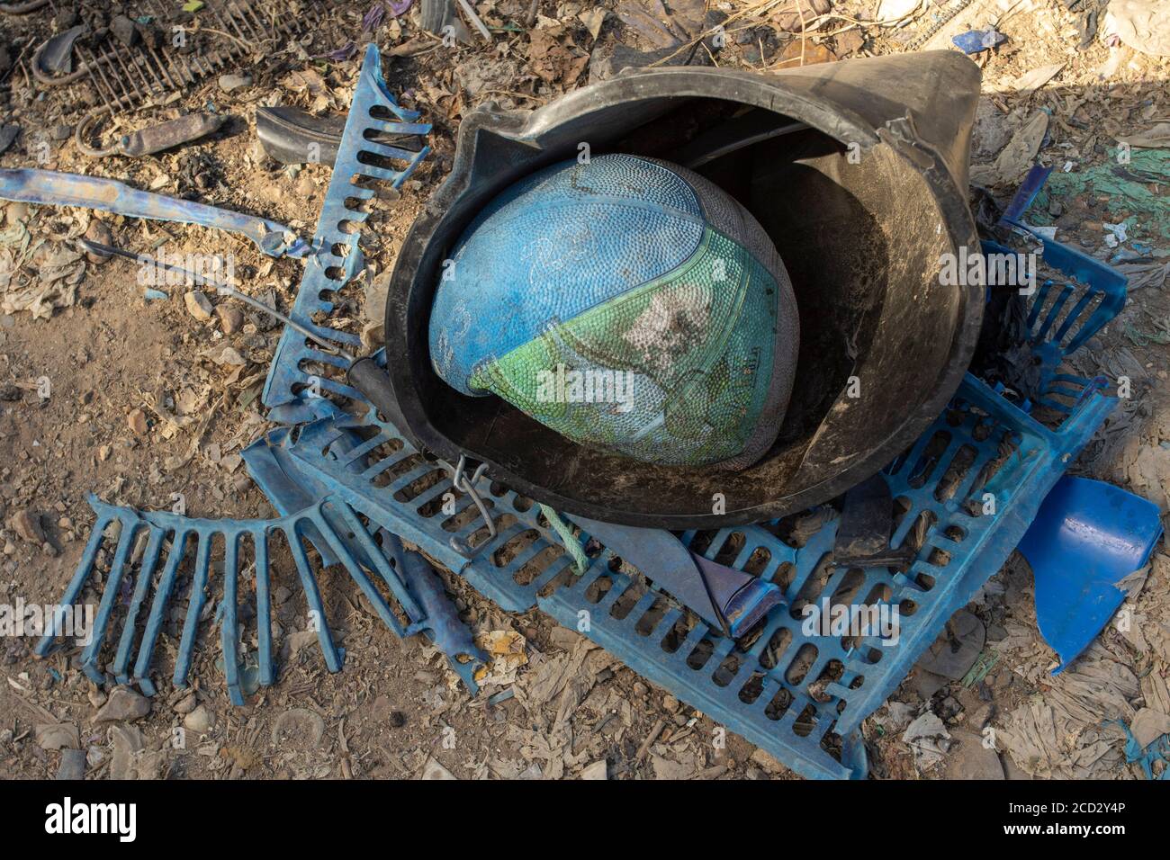Casually discarded household waste littering an alleyway, environmental ...