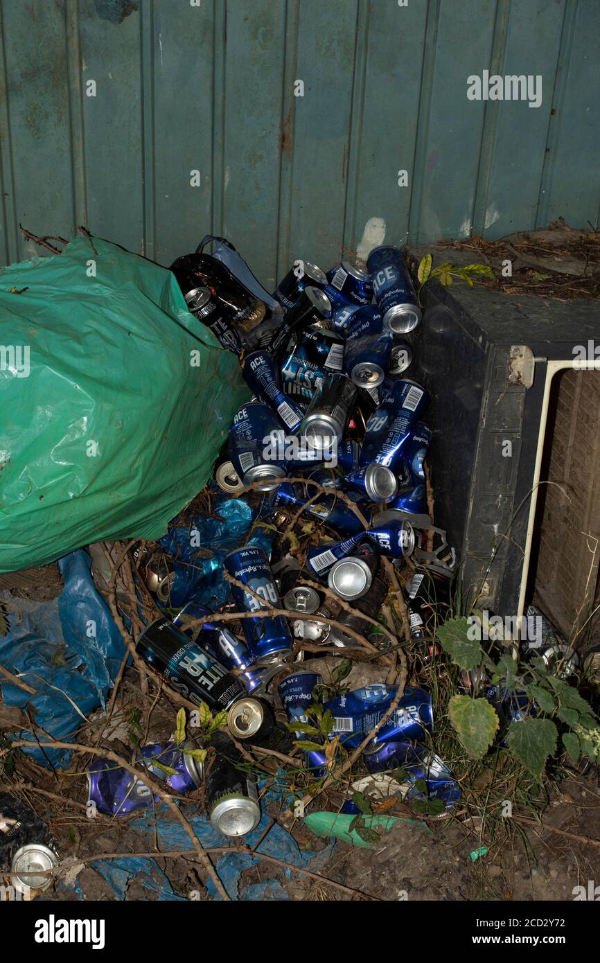 Casually discarded household waste littering an alleyway, environmental ...